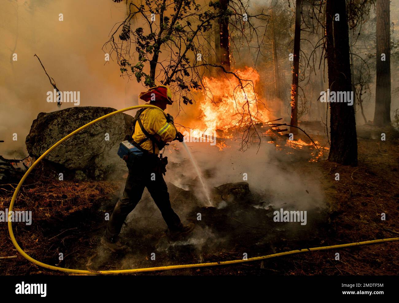 Alhambra firefighter Andrew Nicholson extinguishes flames while ...