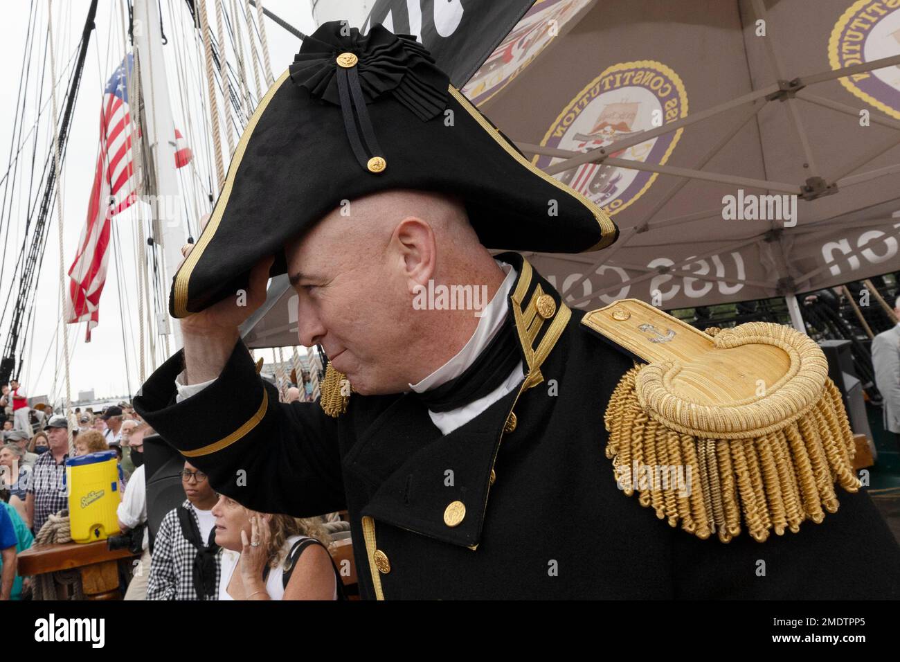 Commanding Officer John Benda salutes as people depart following a ...