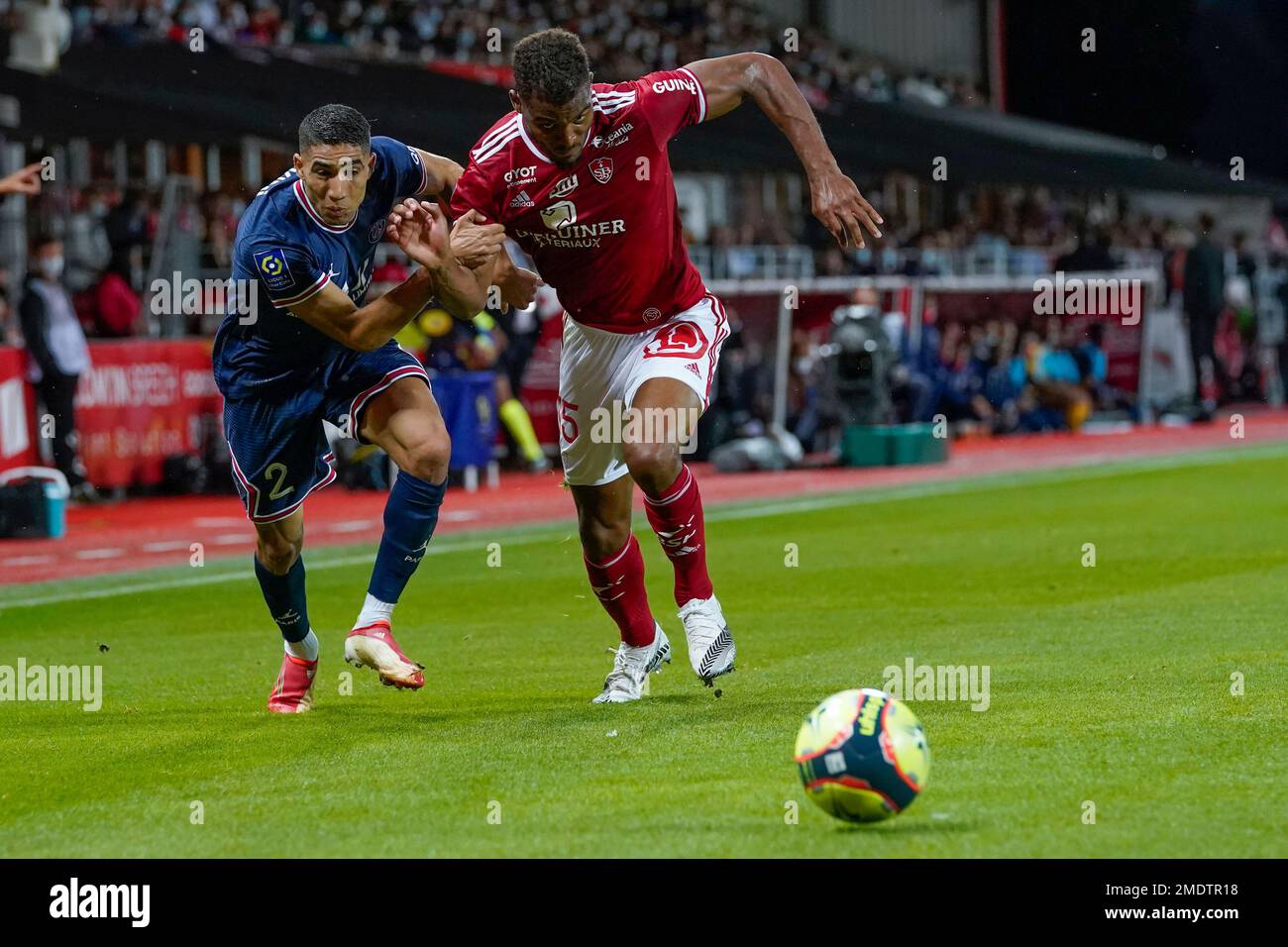 PSG's Achraf Hakimi, left, battles for the ball with Brest's Steve ...