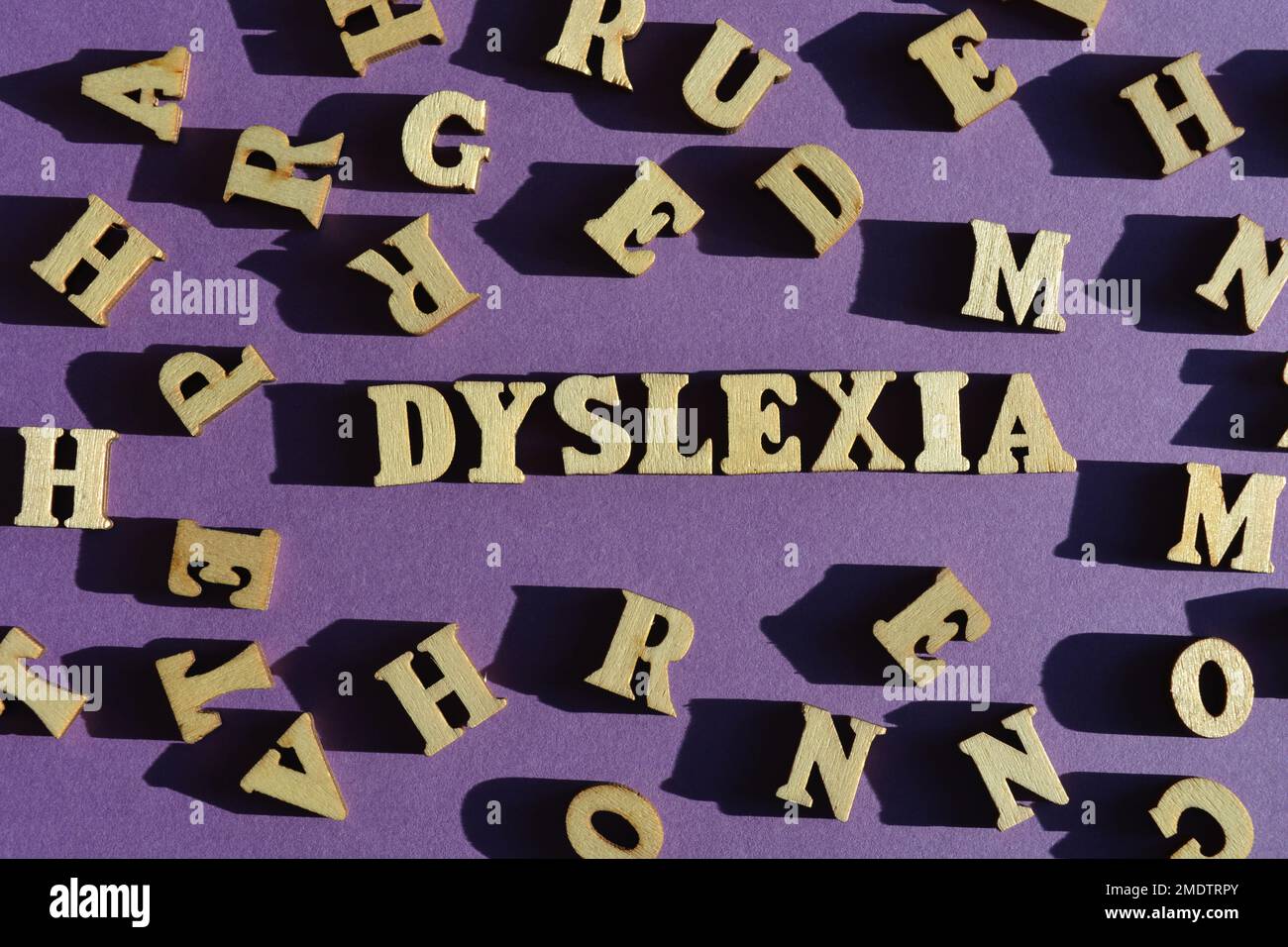 Dyslexia, word in wooden alphabet letters surrounded by random letters ...