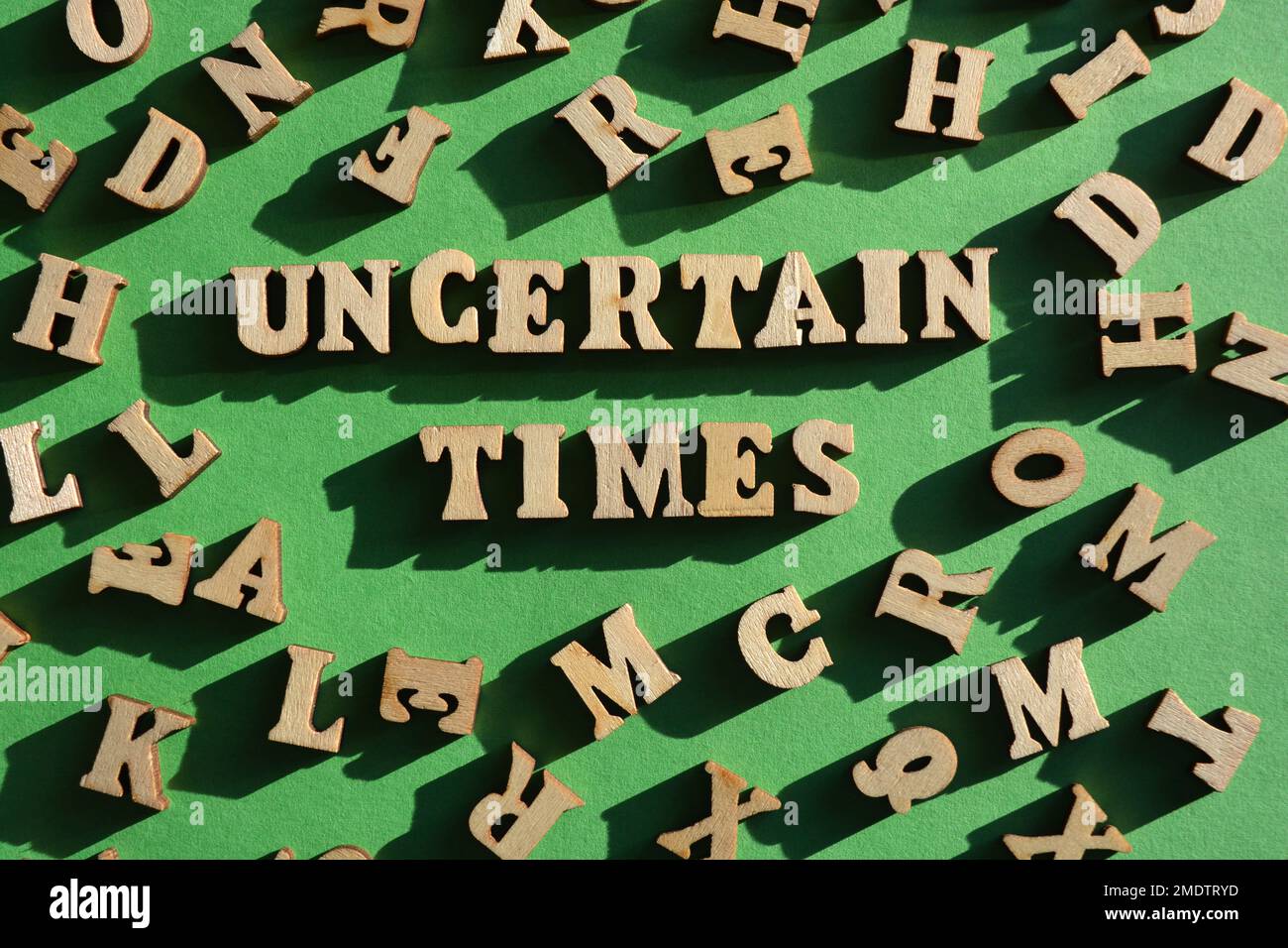 Uncertain Times, words in wooden alphabet letters surround by random ... Uncertain Times, words in wooden alphabet letters surround by random ...