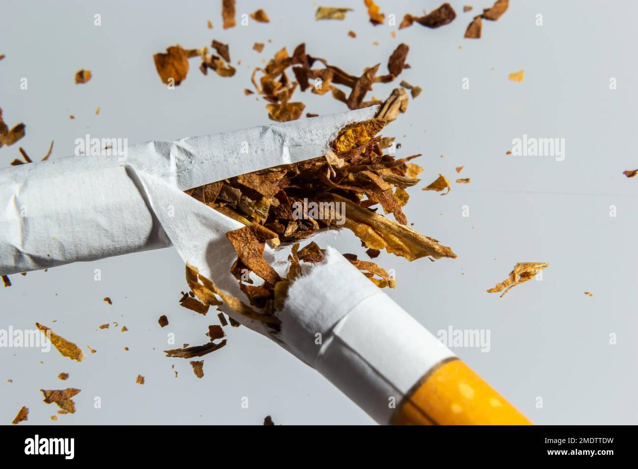 Broken cigarette fly in air on a light background. Conception of ...