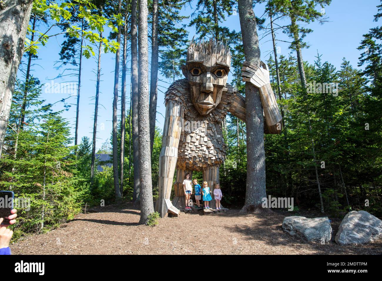 People pose for photos with Roskva, a giant troll sculpture made from ...
