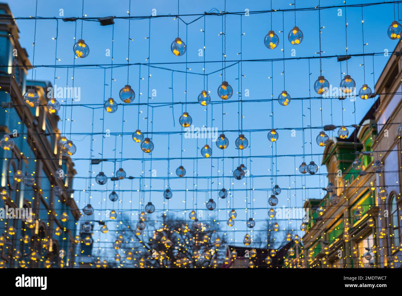 Festive hanging garlands with glowing light bulbs against the ...