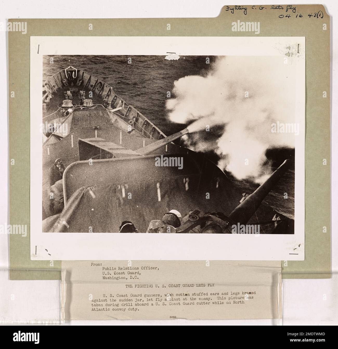 U.S. Coast Guard gunners brace themselves against the recoil as they ...