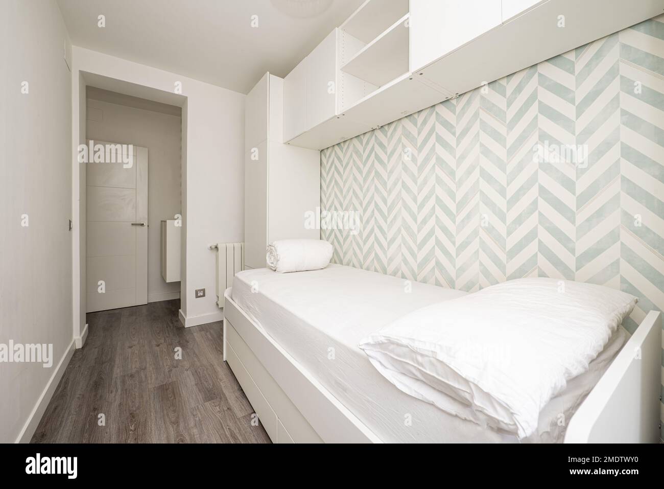 Bedroom with single bed and wardrobe bridge and white bookshelf Stock ...