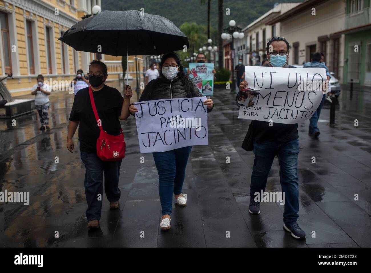 Local journalists hold signs that read in Spanish "Justice for Jacinto ...