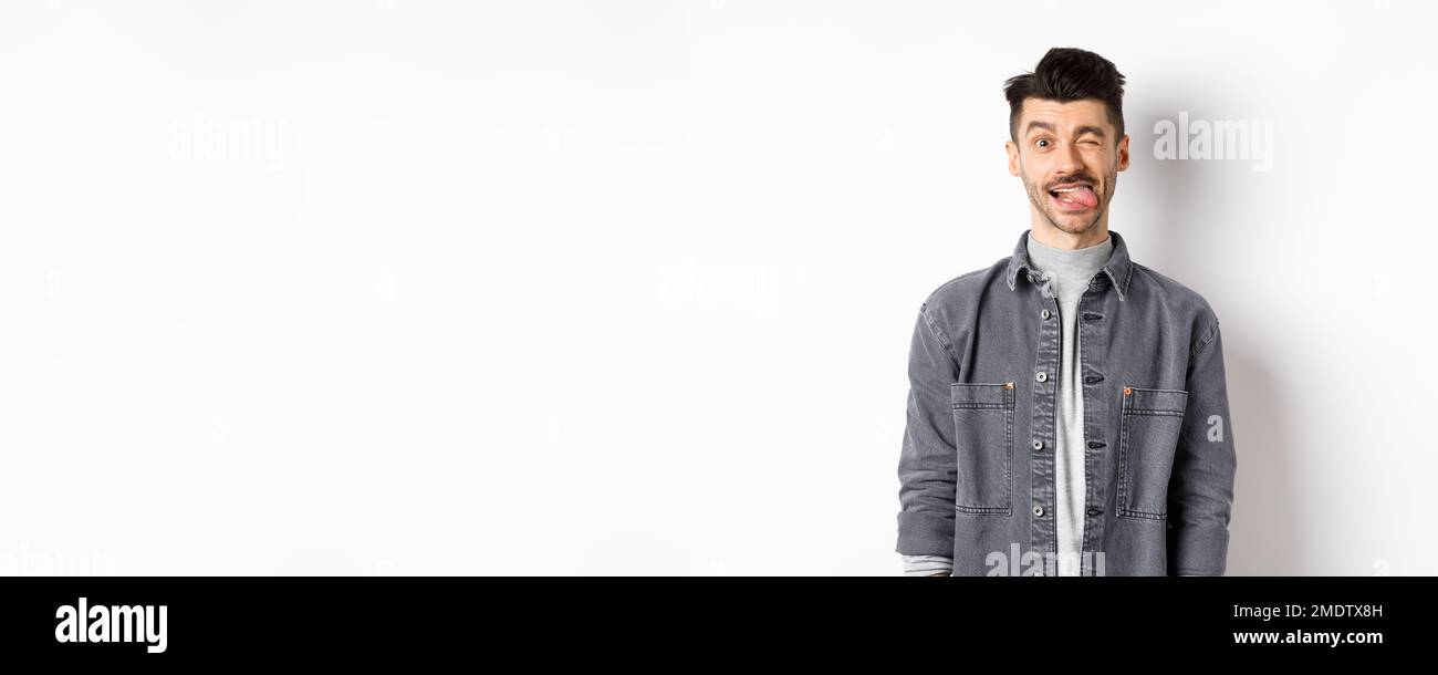 Funny guy with moustache showing tongue and winking, making you laugh ...