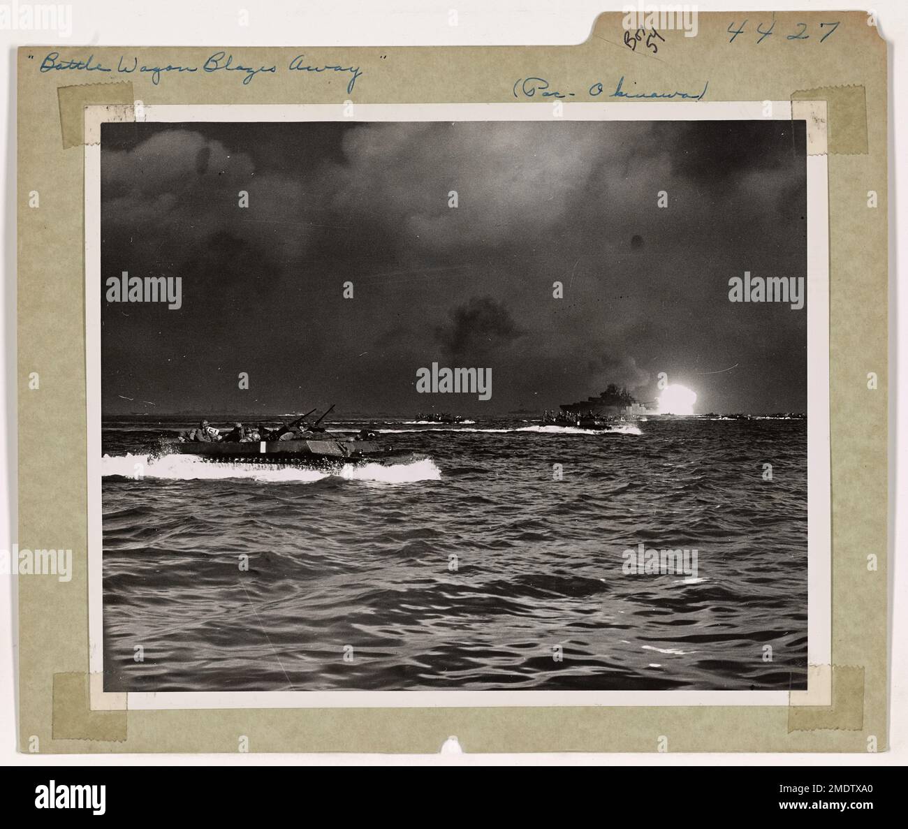 Amtracs from a Coast Guard-manned LST surge toward the beach during the ...