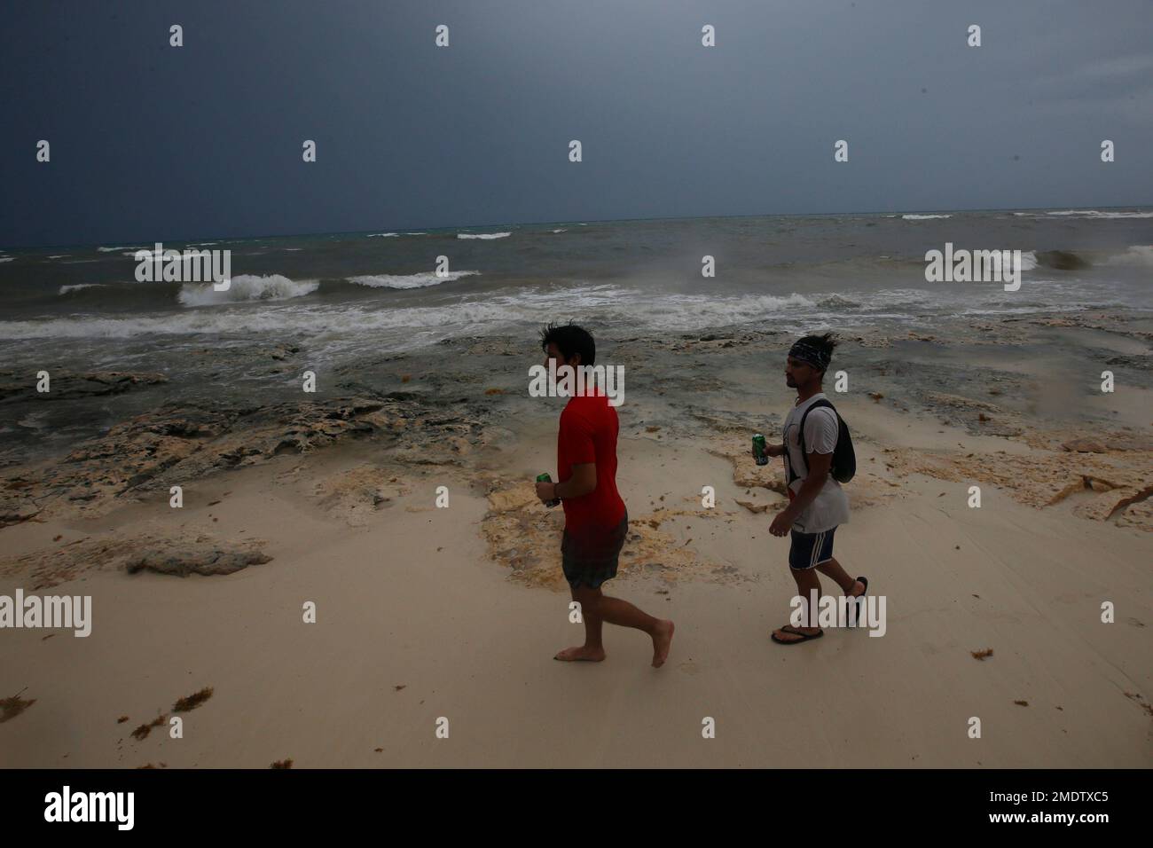 People walk on the beach after Hurricane Grace hit Playa del Carmen ...