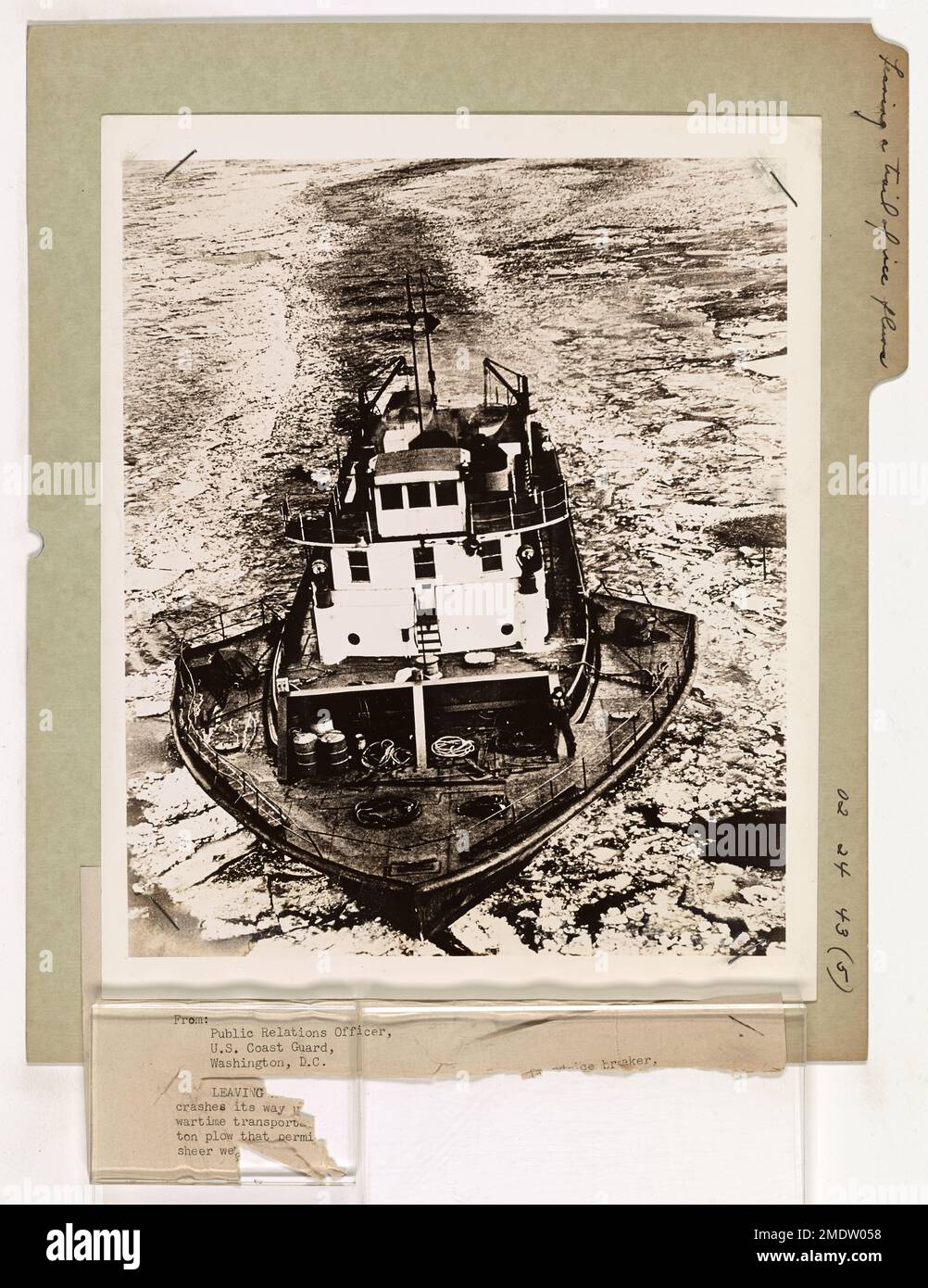 A U.S. Coast Guard icebreaker is shown navigating through a river to ...