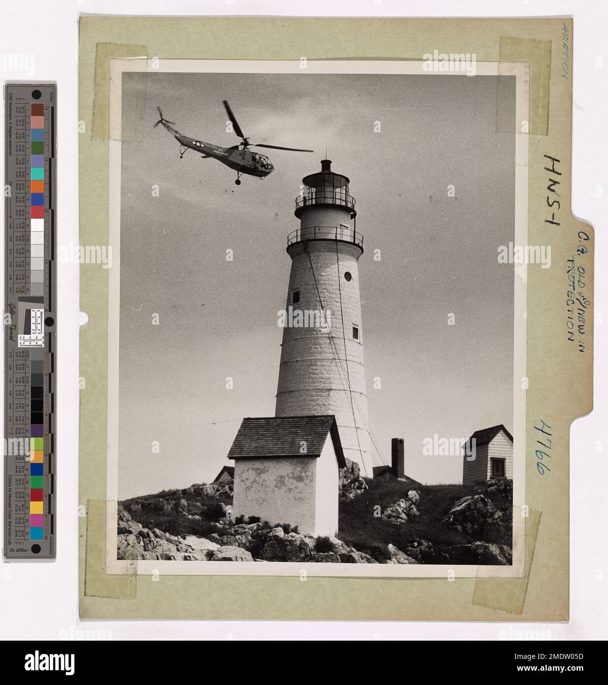 A Coast Guard helicopter hovers above Boston Lighthouse, which has ...