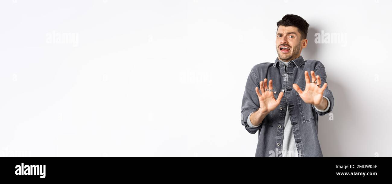 Stay away from me. Scared young man screaming and asking to stop, step ...