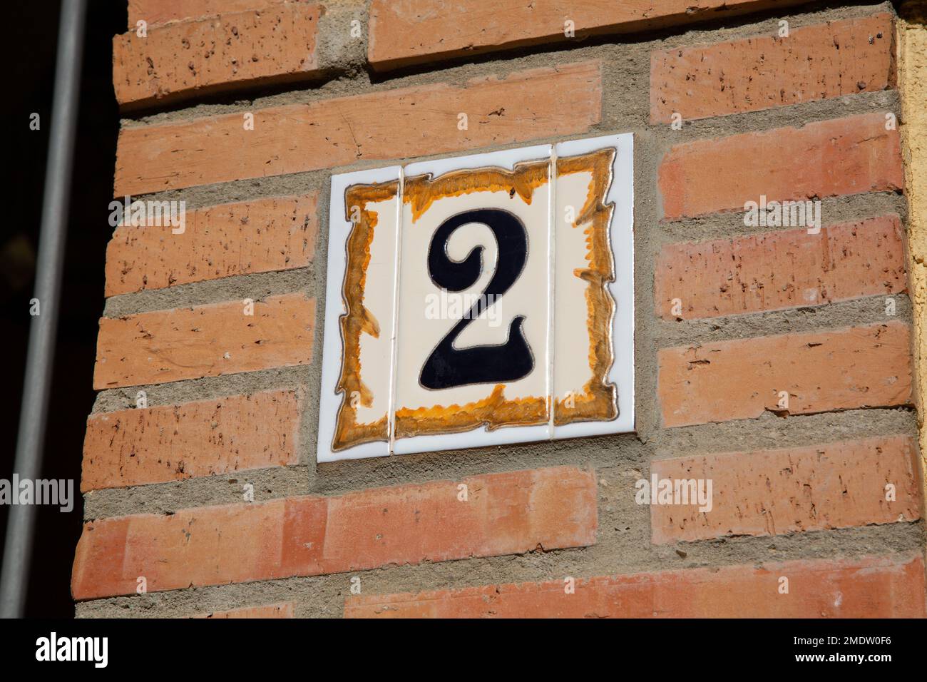 Number Two on Brick Wall Building Facade Stock Photo - Alamy