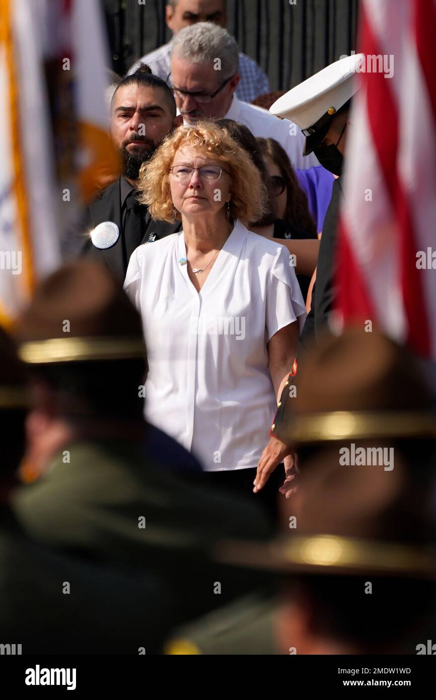 Elizabeth French, in white, and her son Andrew, left, watch as the body ...