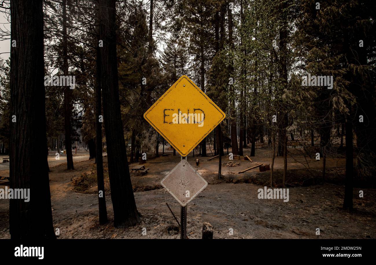 A partially melted street sign marks the end of a Tyler Drive as the ...