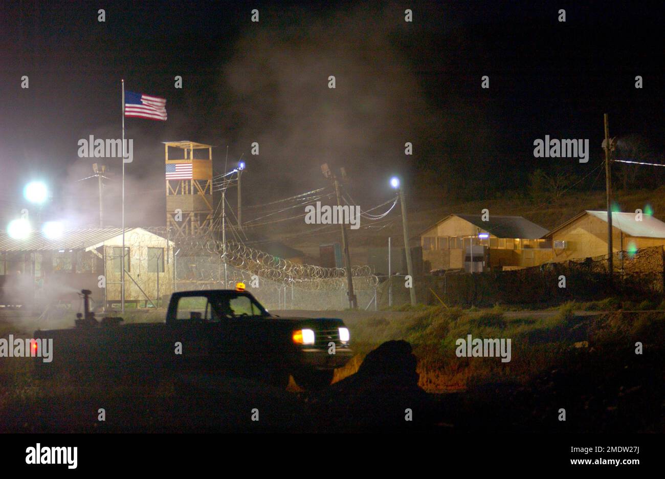 A truck sprays pesticides in the air outside Camp X-Ray at the ...