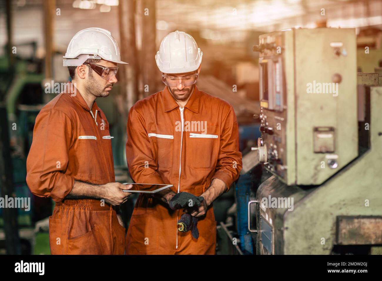 Engineer industry worker work help together training new young employee ...