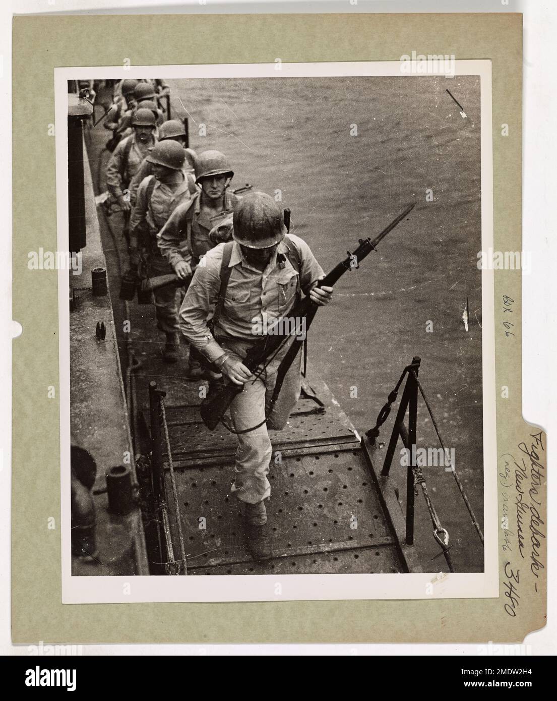 Helmeted American soldiers disembark from a Coast Guard-manned LCI ...