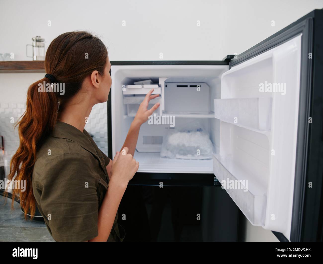 Woman smiling with teeth looking into camera in kitchen at home opened ...