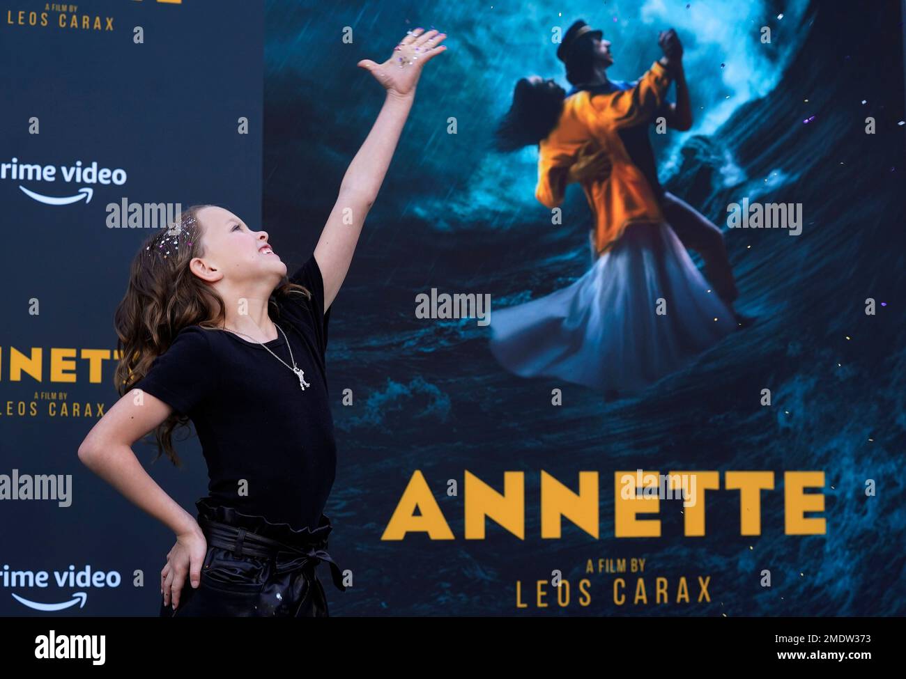 Devyn McDowell, a cast member in "Annette," throws glitter in the air ...