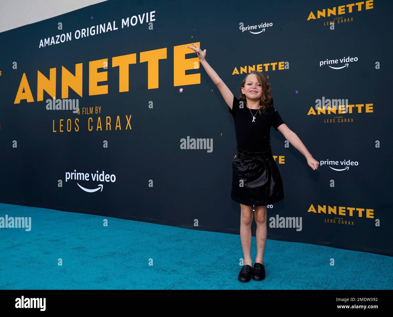 Devyn McDowell, a cast member in "Annette," throws glitter as she poses ...