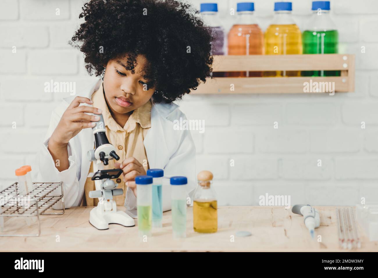 Scientist Kid play in school science lab kit. Learning education black ...