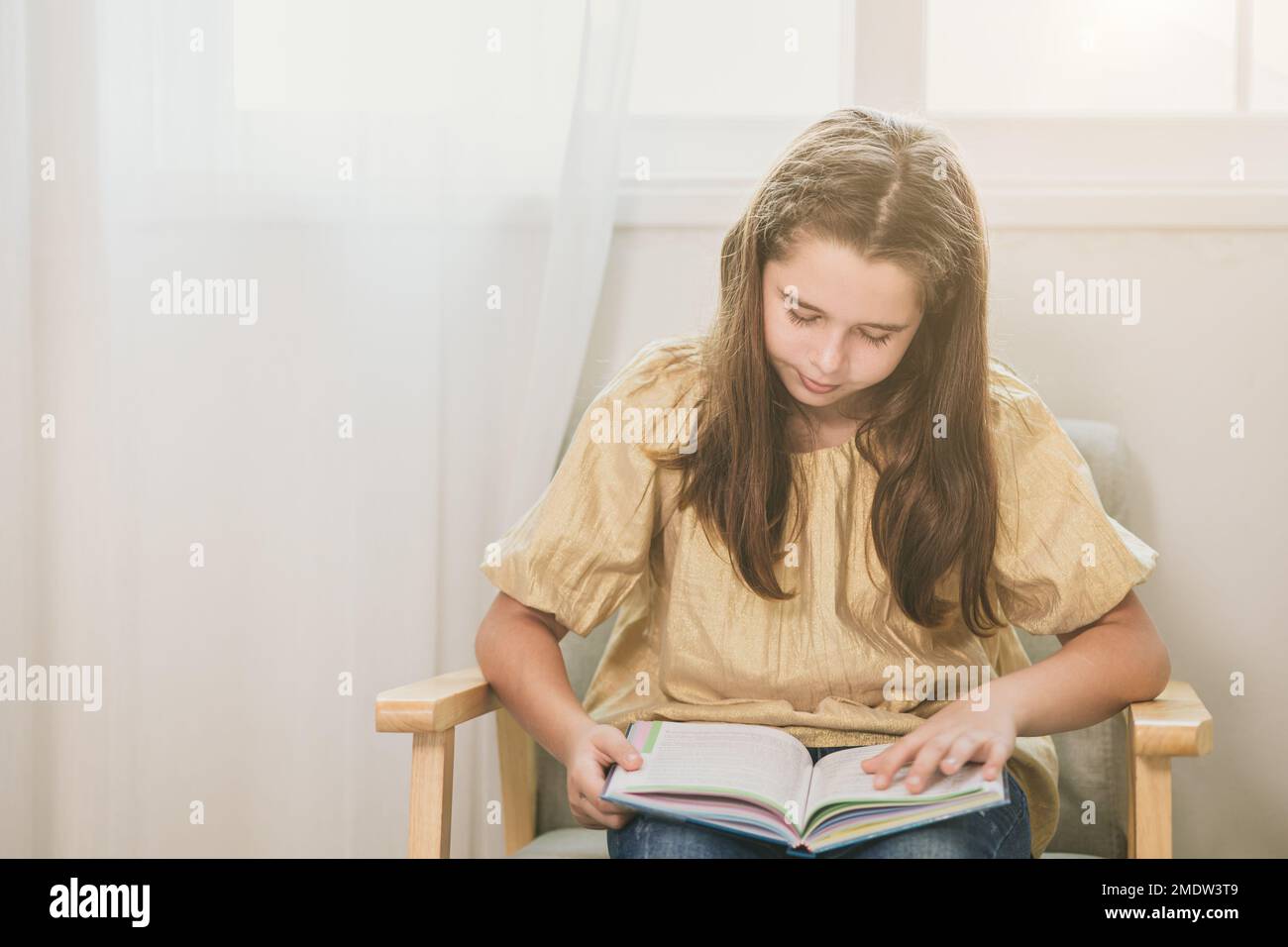 cute child girl reading a book at home for bookworm nerdy smart kid learning self education ...