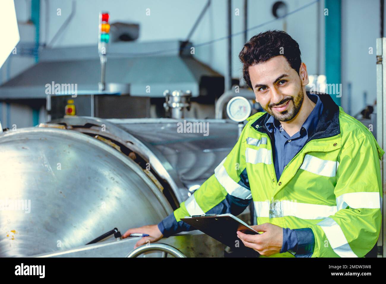 Happy engineer male worker working in factory work check boiler water ...
