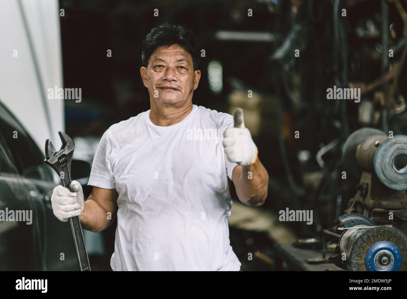 portrait happy Asian adult male worker dirty with oil grease standing ...