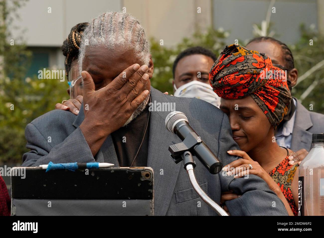 Joe Powell is comforted by his daughter, Nakia Porter, right, during a ...