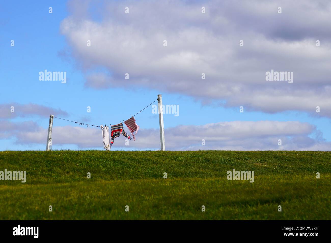 Clothes hanging on a clothesline to dry Stock Photo - Alamy