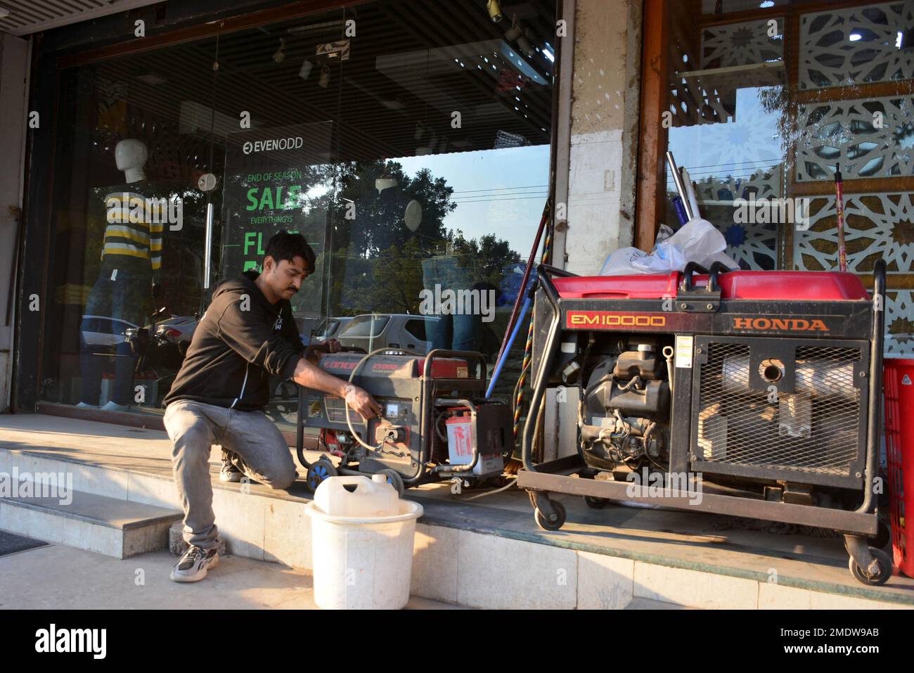 Hyderabad, Pakistan. 23rd Jan, 2023. A shopkeeper starts a generator ...