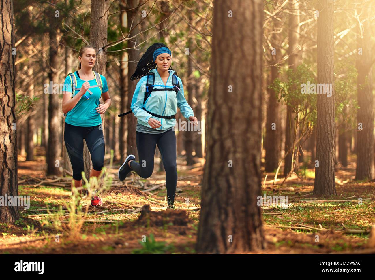 Nature is a good place to get your healthy on. two sporty young women ...