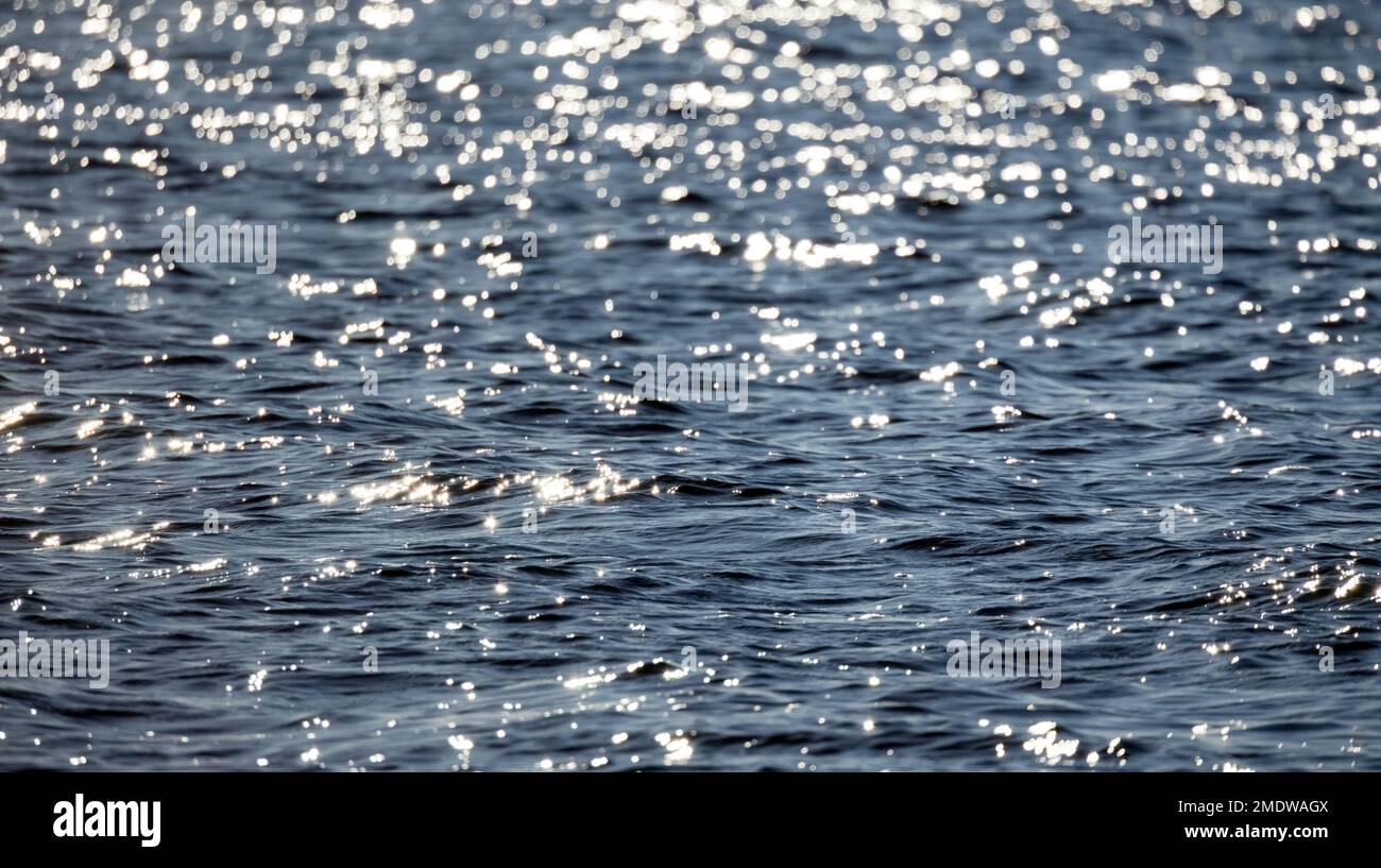 Shiny blue sea water with bright shiny sunbeams, natural background ...