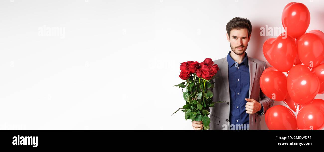 Confident boyfriend in suit going on romantic date, winking at camera ...