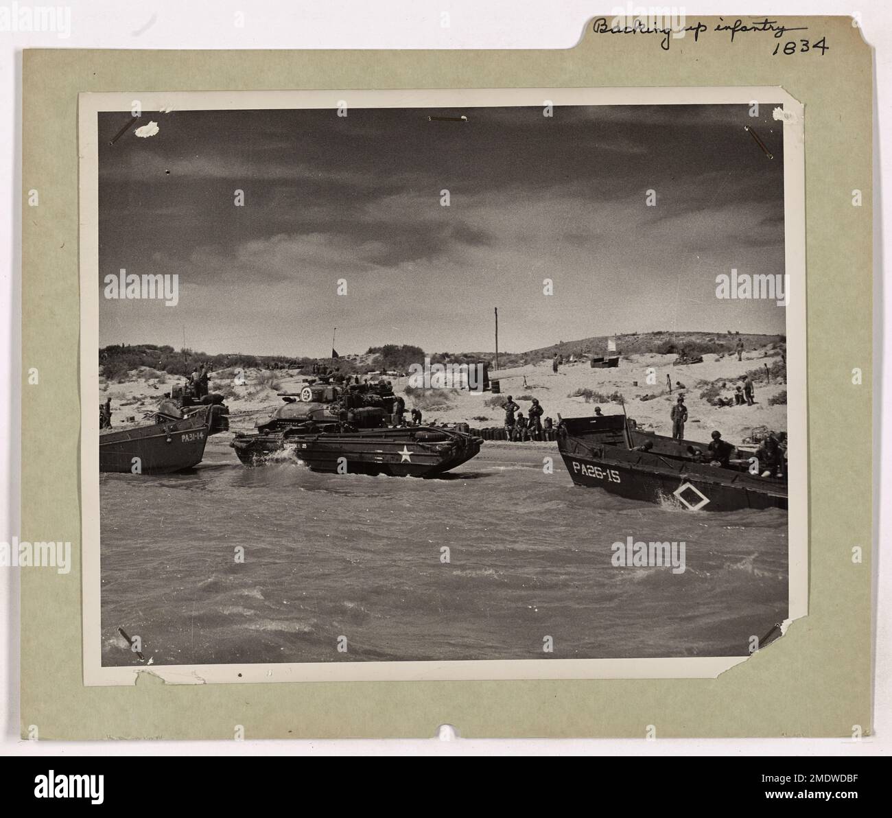 U.S. Coast Guard-manned landing barges and amphibious trucks are shown ...