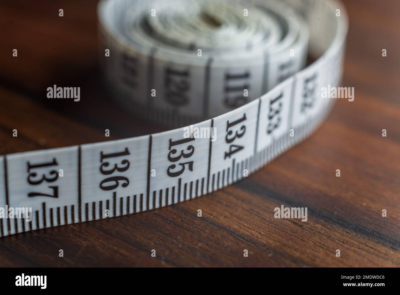 Close up tailor measuring tape on wooden table background. White ...
