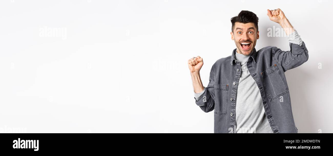 Excited man shouting from joy, winning prize and rejoicing, raising ...