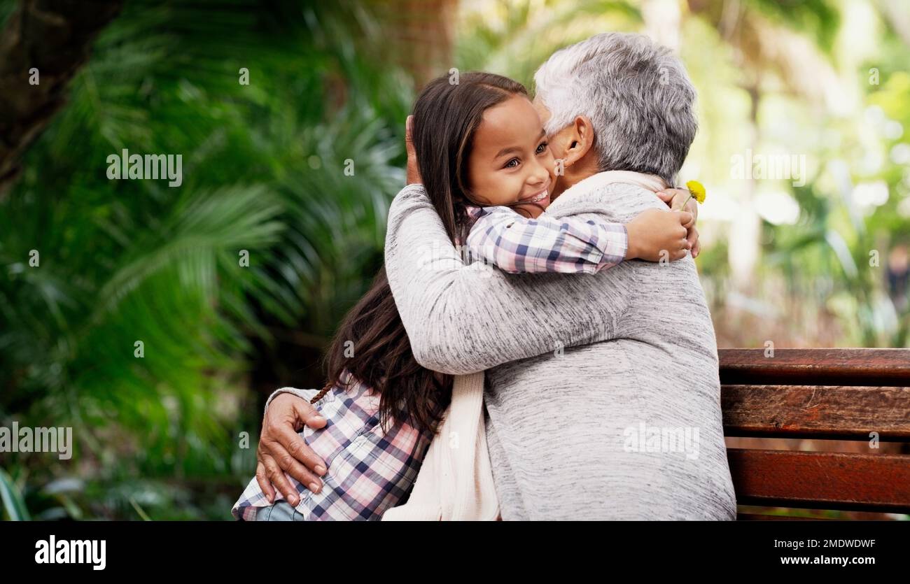 We share a special bond between us. an adorable little girl hugging her grandmother in the park ...