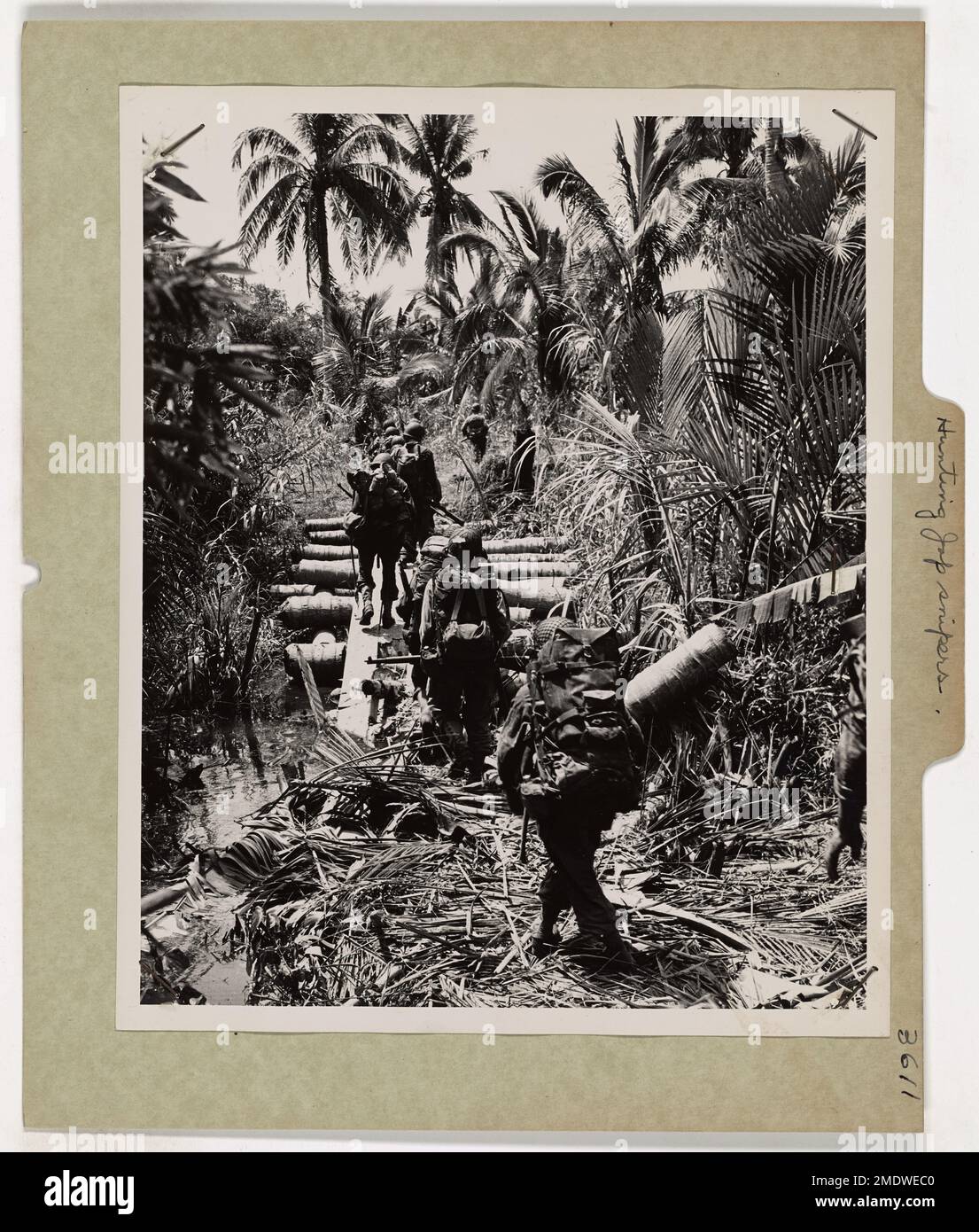 U.S. troops move through the dense jungle of Leyte Island, preparing ...