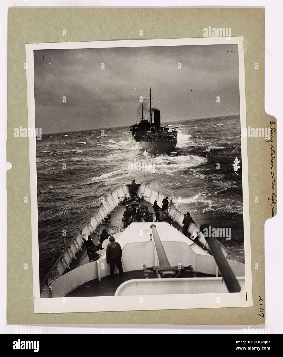 A U.S. Coast Guard combat cutter refuels at sea from a British tanker ...