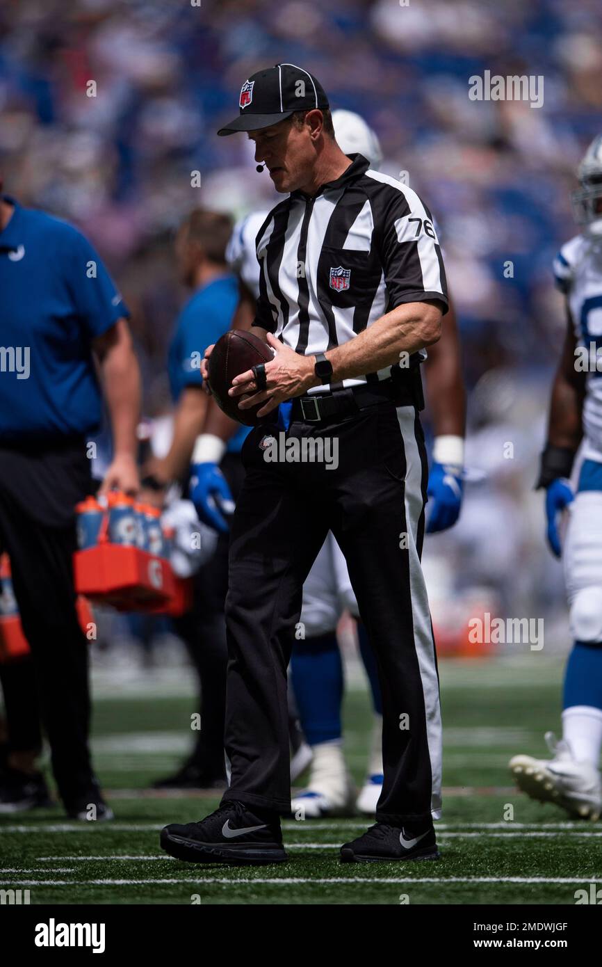 NFL umpire Alan Eck (76) carries the football down the field during an ...
