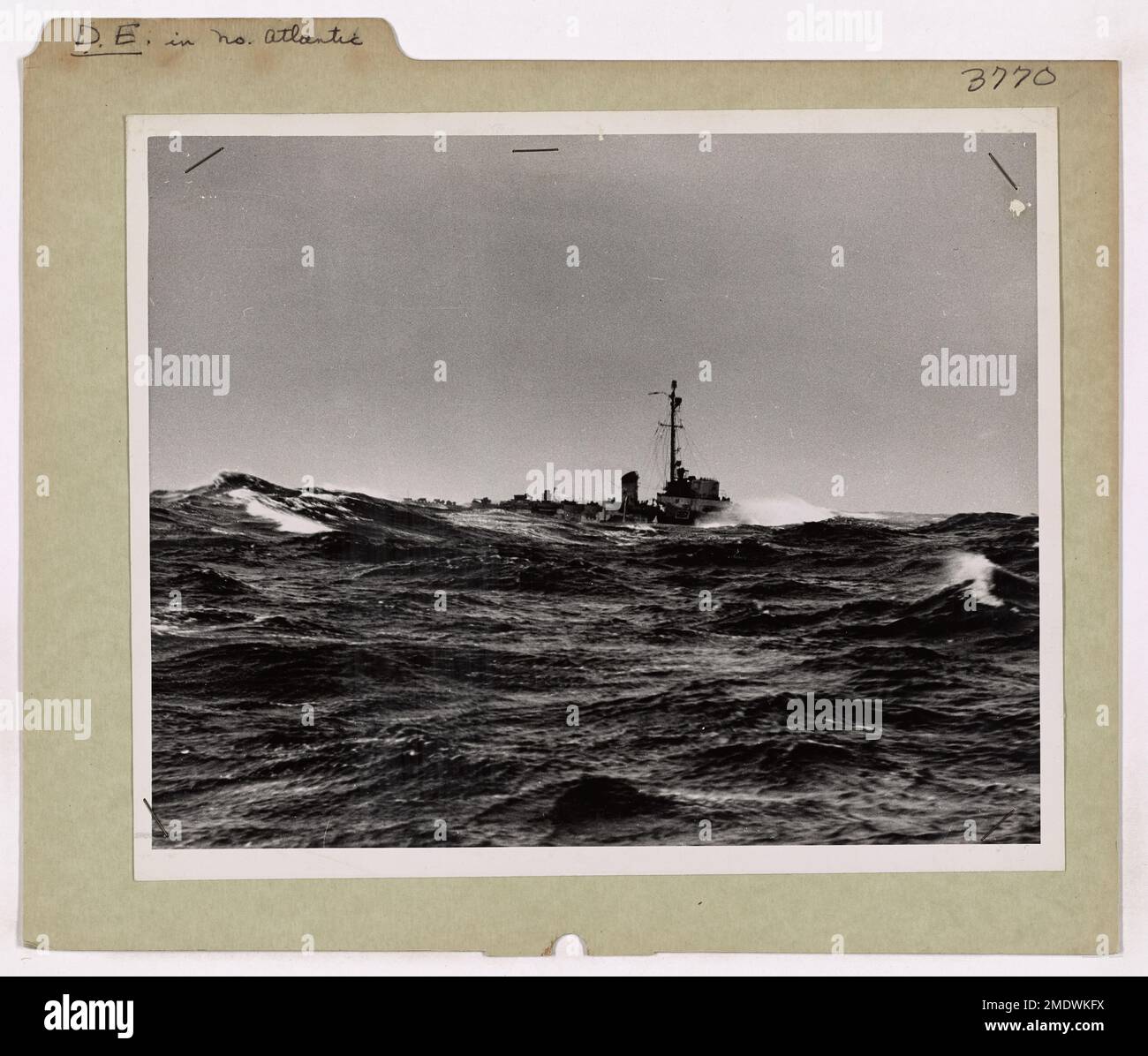 This image depicts a U.S. Coast Guard destroyer navigating through ...