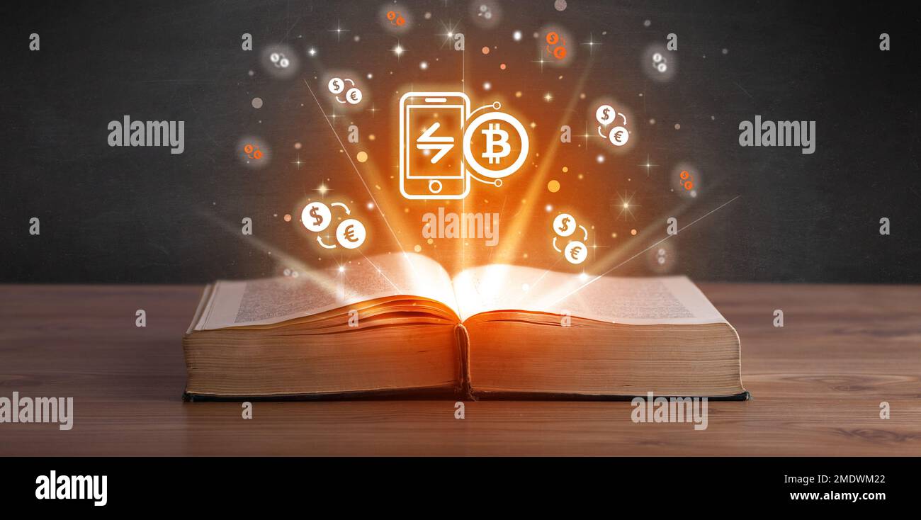 Open book with currency icons above Stock Photo - Alamy