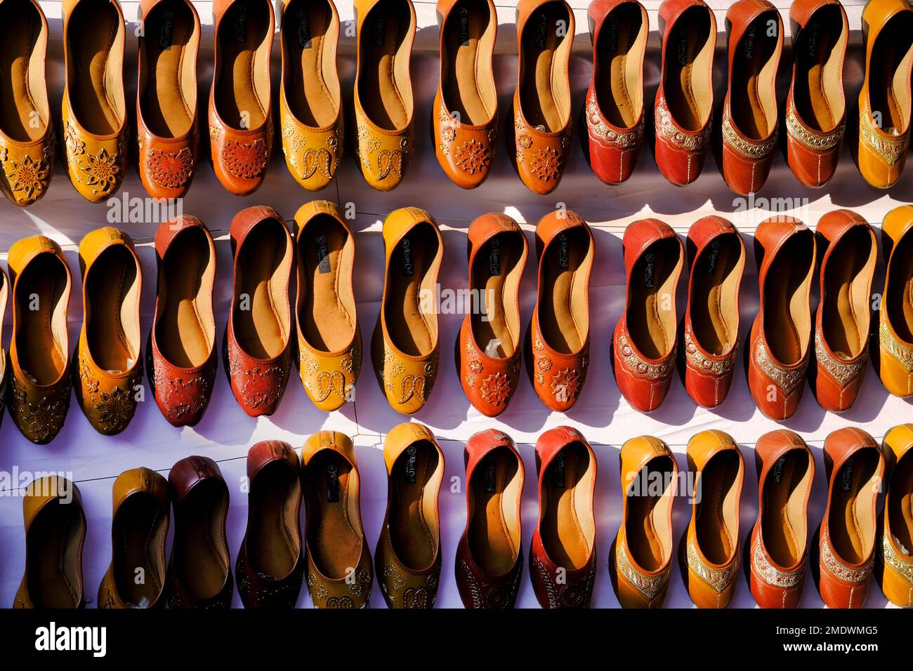 Colorful Handmade chappals (sandals) being sold in an Indian market ...