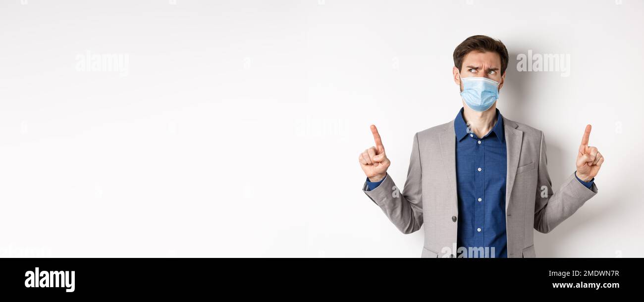 Covid-19, pandemic and business concept. Suspicious businessman in ...