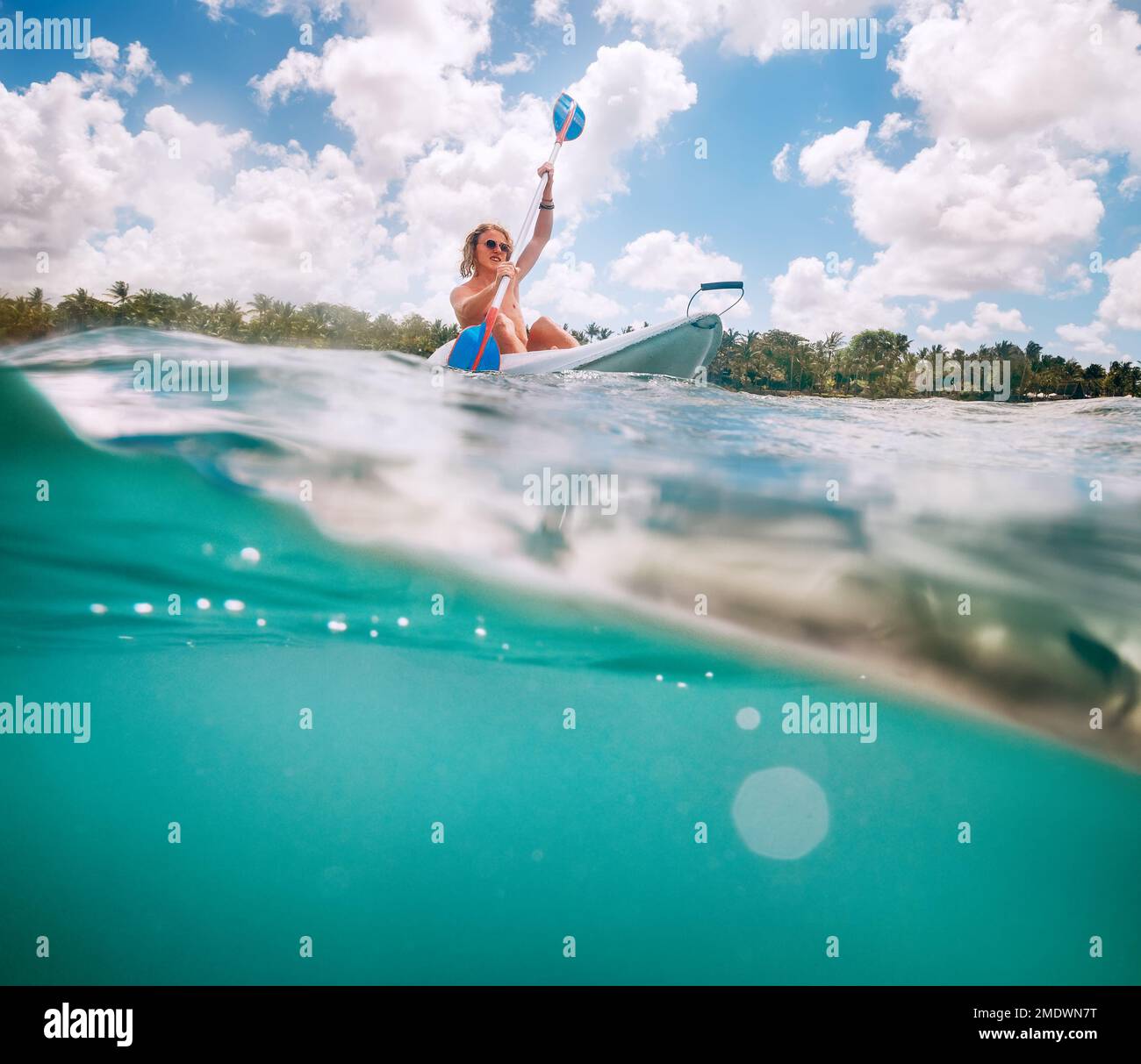 Underwater view angle to a smiling blonde teenage boy in fashion ...