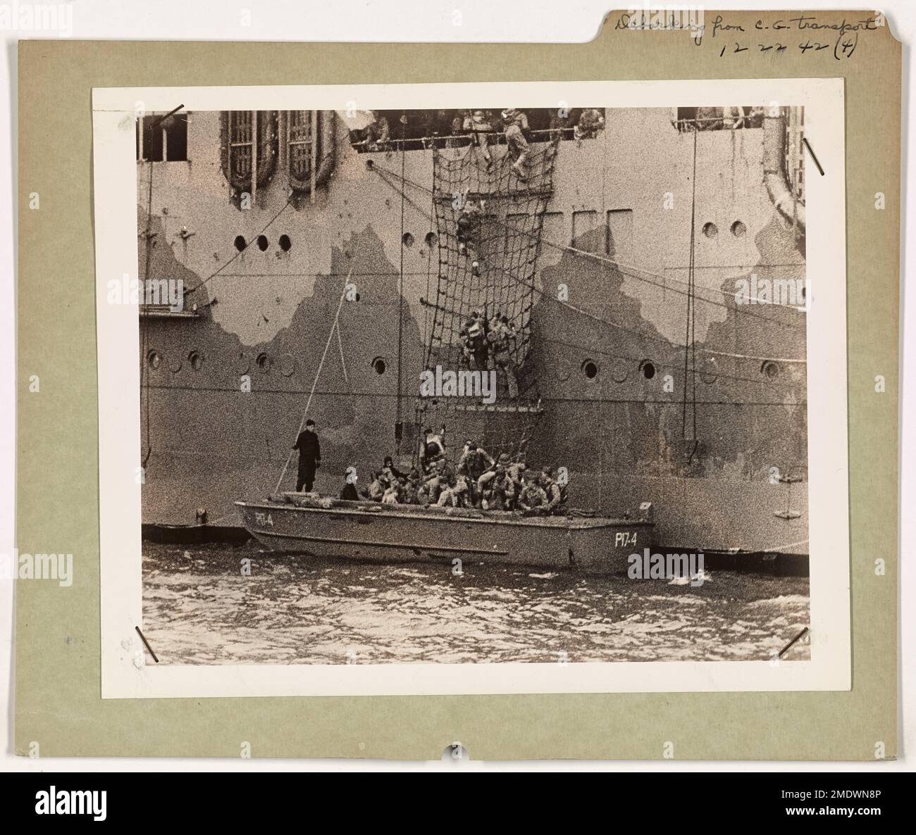 Marines are shown disembarking from a Coast Guard-manned landing barge ...