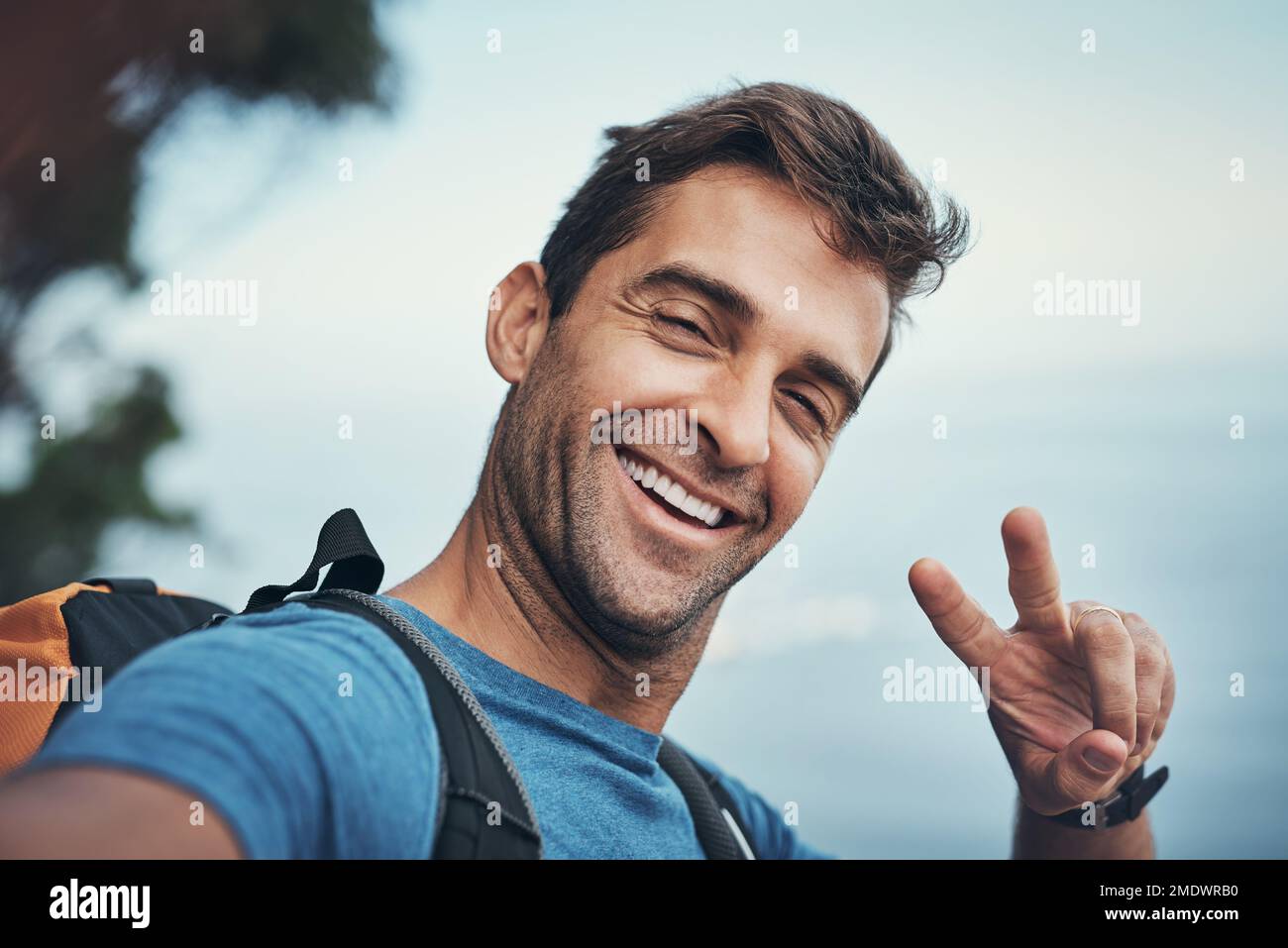 Only peace and harmony. Portrait of a cheerful young man showing the ...